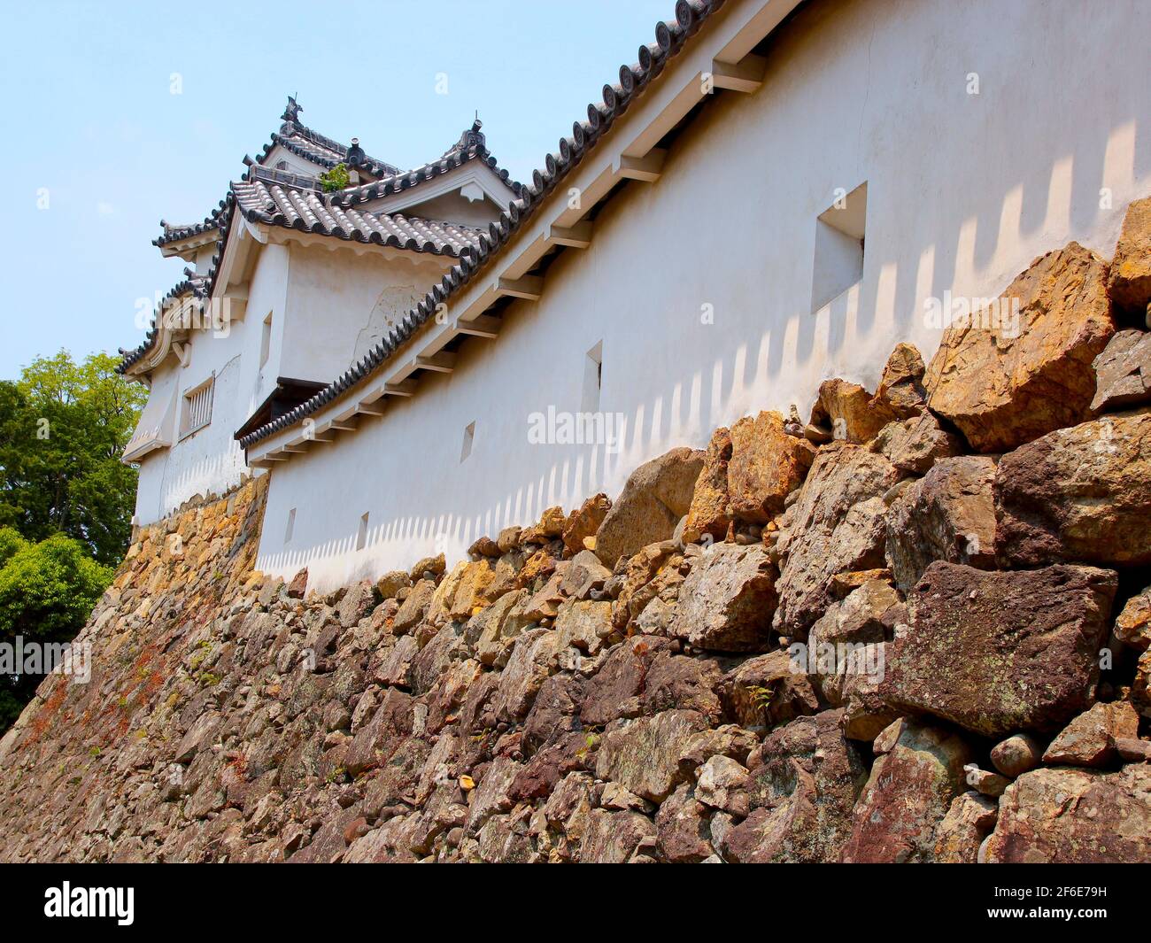 Detail of the iconic stone, whitewashed stucco wall and building in the ...