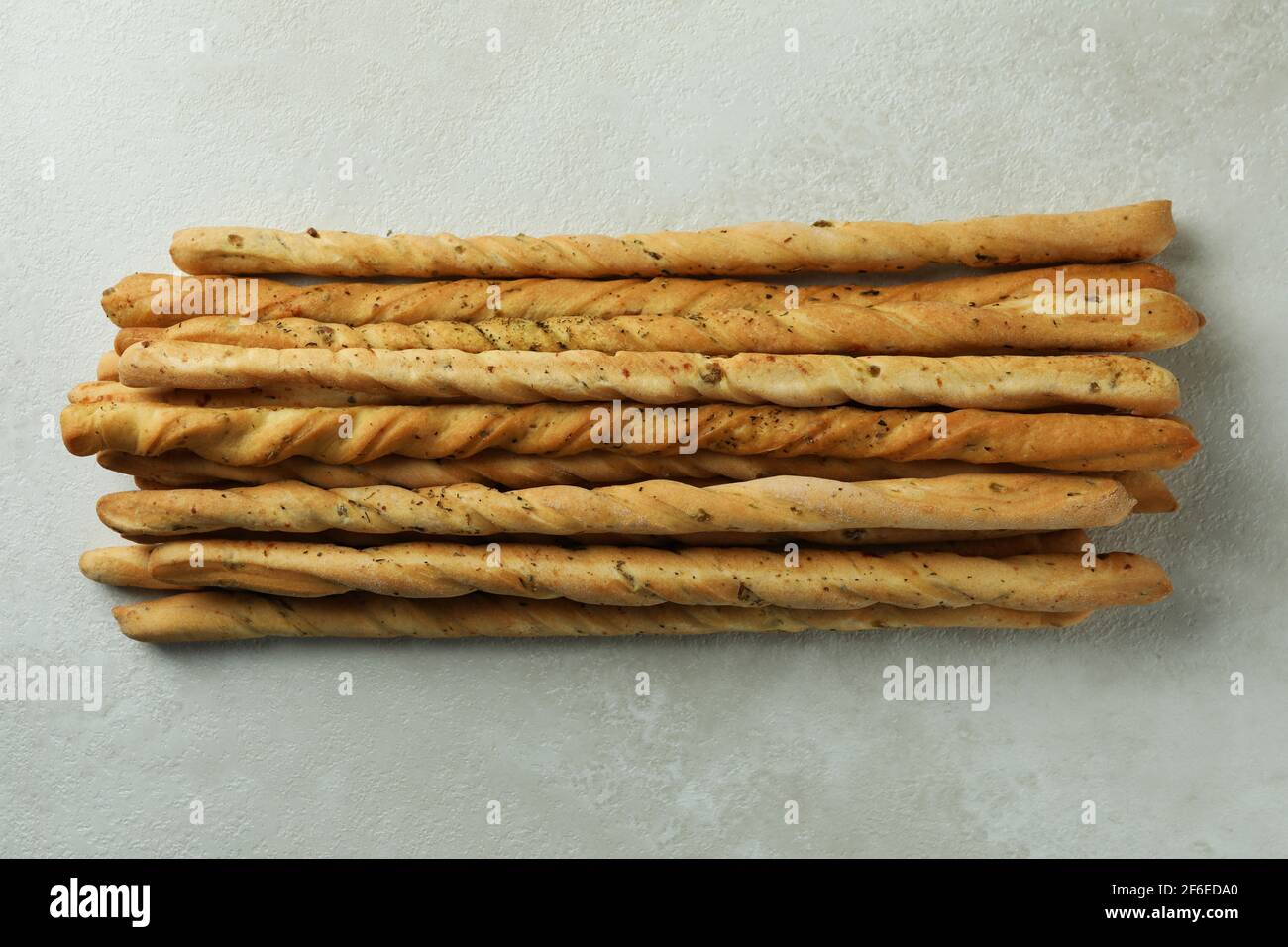 Tasty grissini breadsticks on white textured background Stock Photo - Alamy