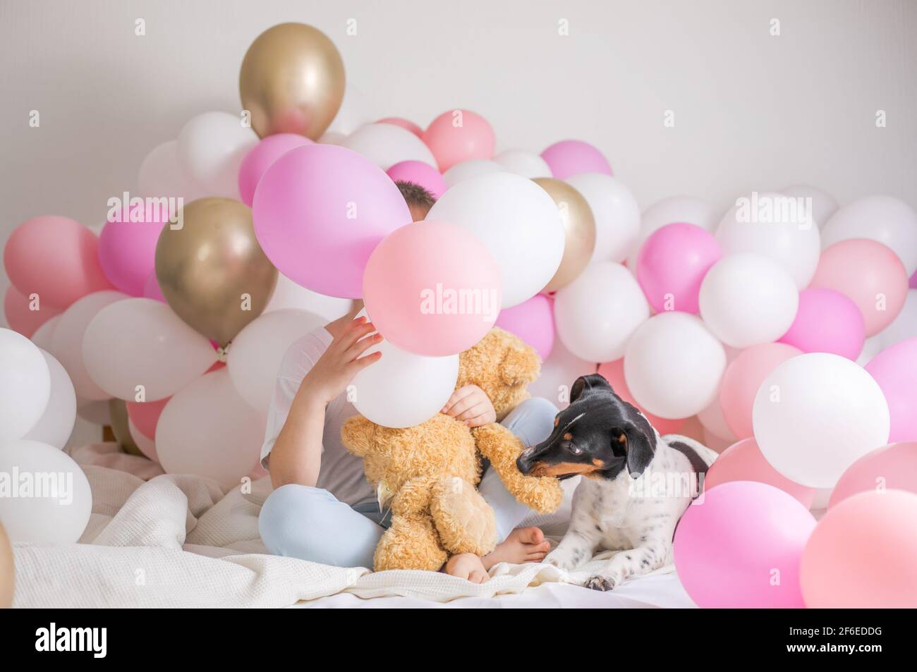 Faceless child behind helium balloon celebrates birthday over white ...