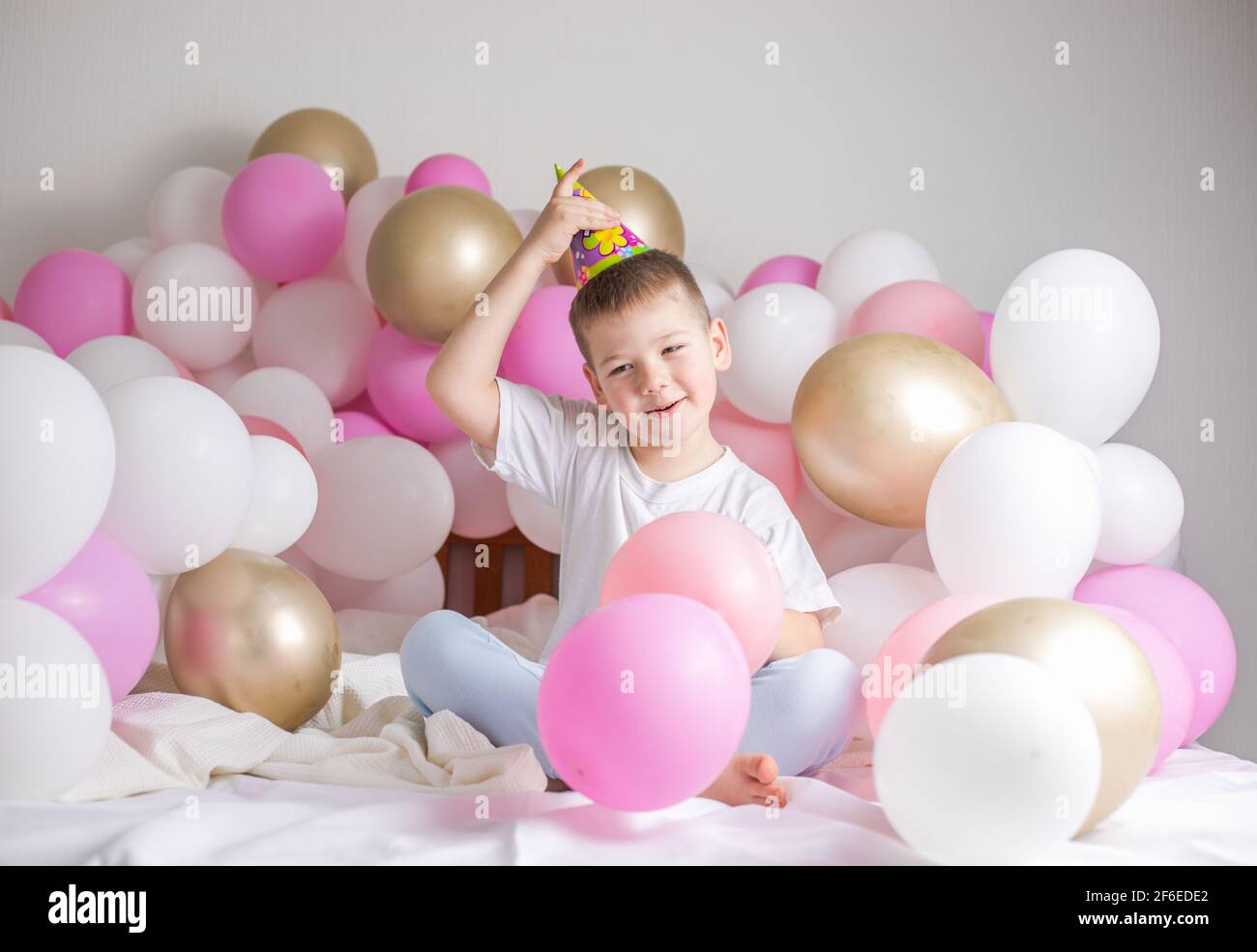 Little boy in white balloons . Small child with party balloons ...