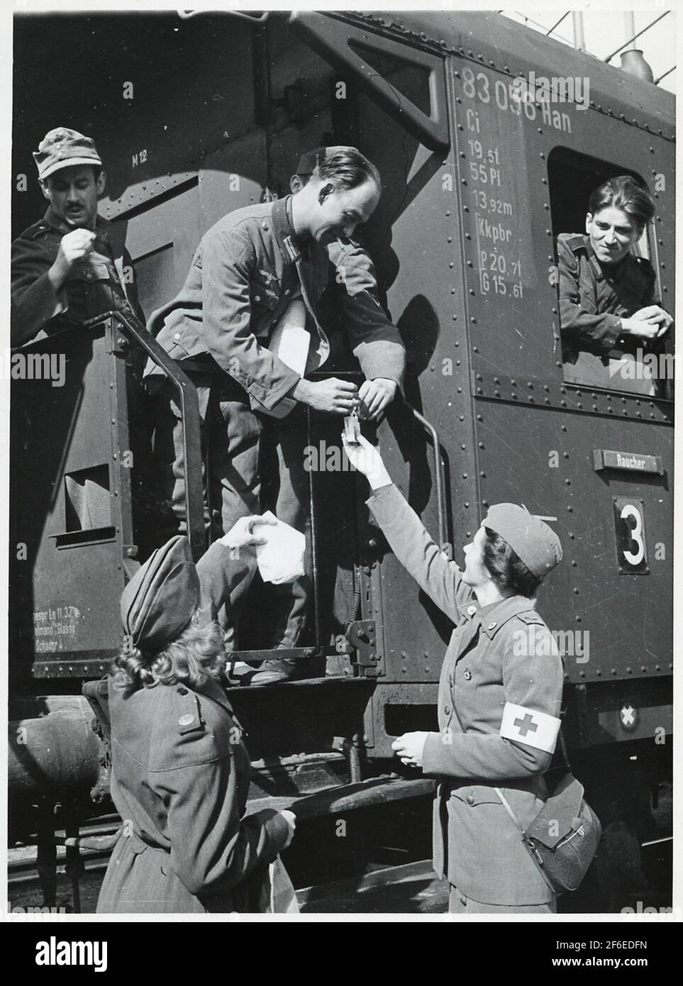 Red cross sisters submit supplies to damaged German soldiers on board a ...