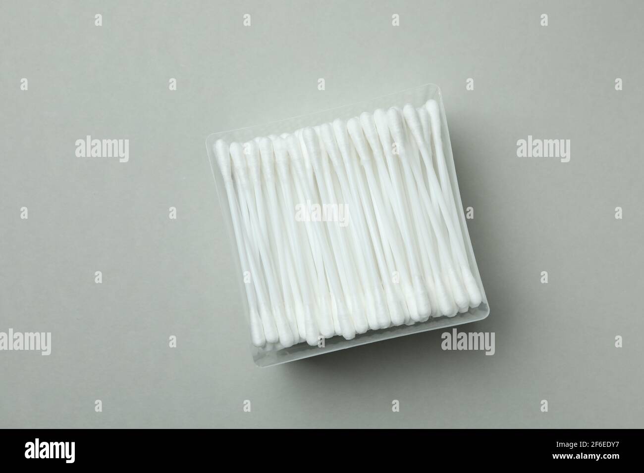 Plastic box with cotton swabs on light gray background Stock Photo - Alamy