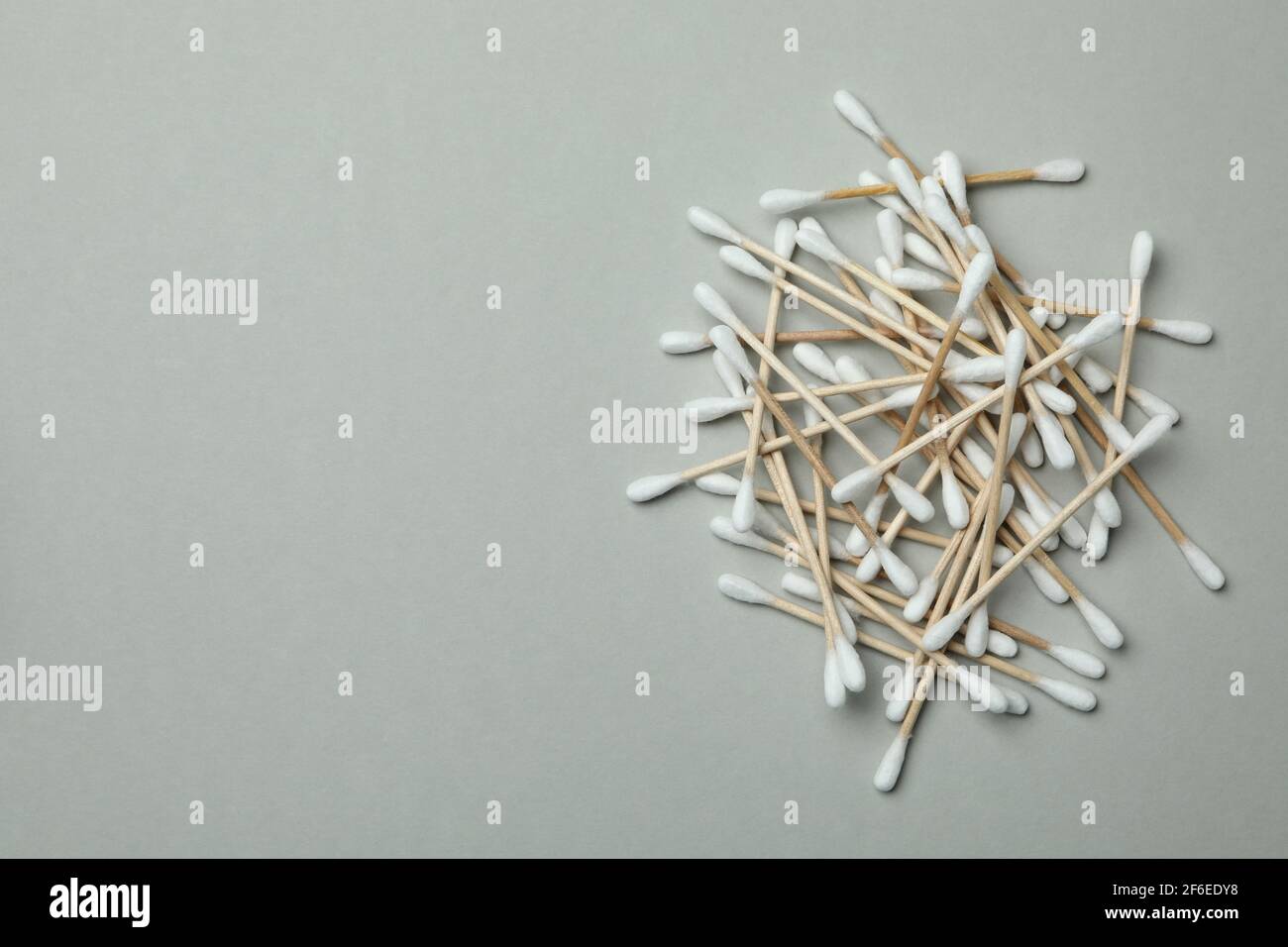 Wooden cotton swabs on light gray background, space for text Stock ...