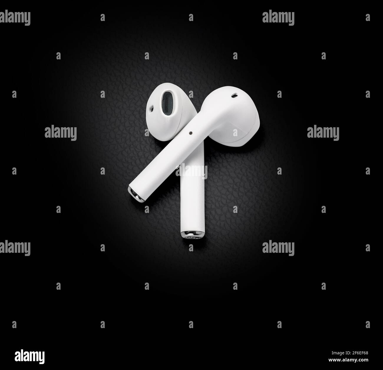 White headphones wireless earphones isolated on black background with ...