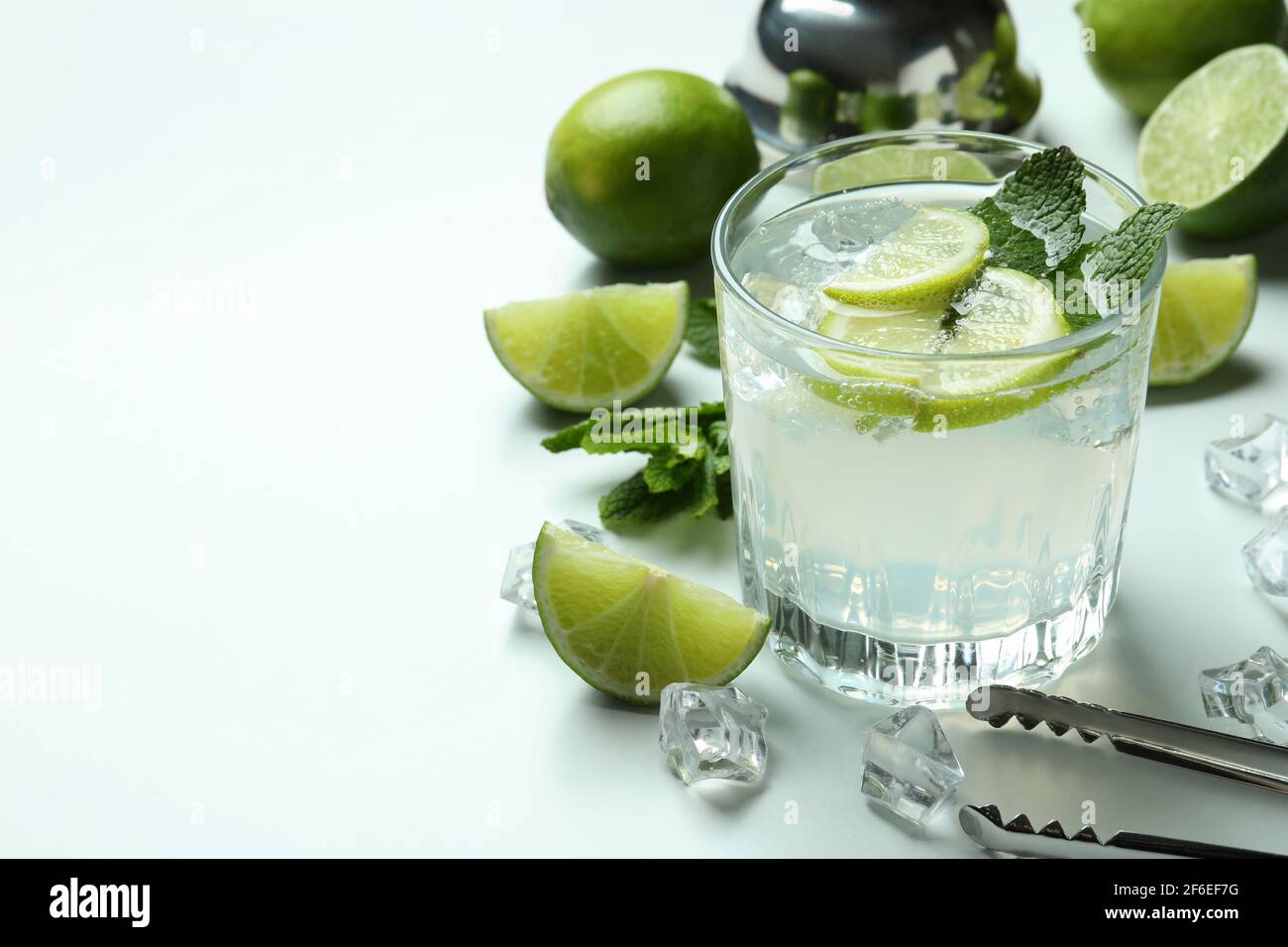 Glass of mojito cocktail and ingredients on white background Stock ...