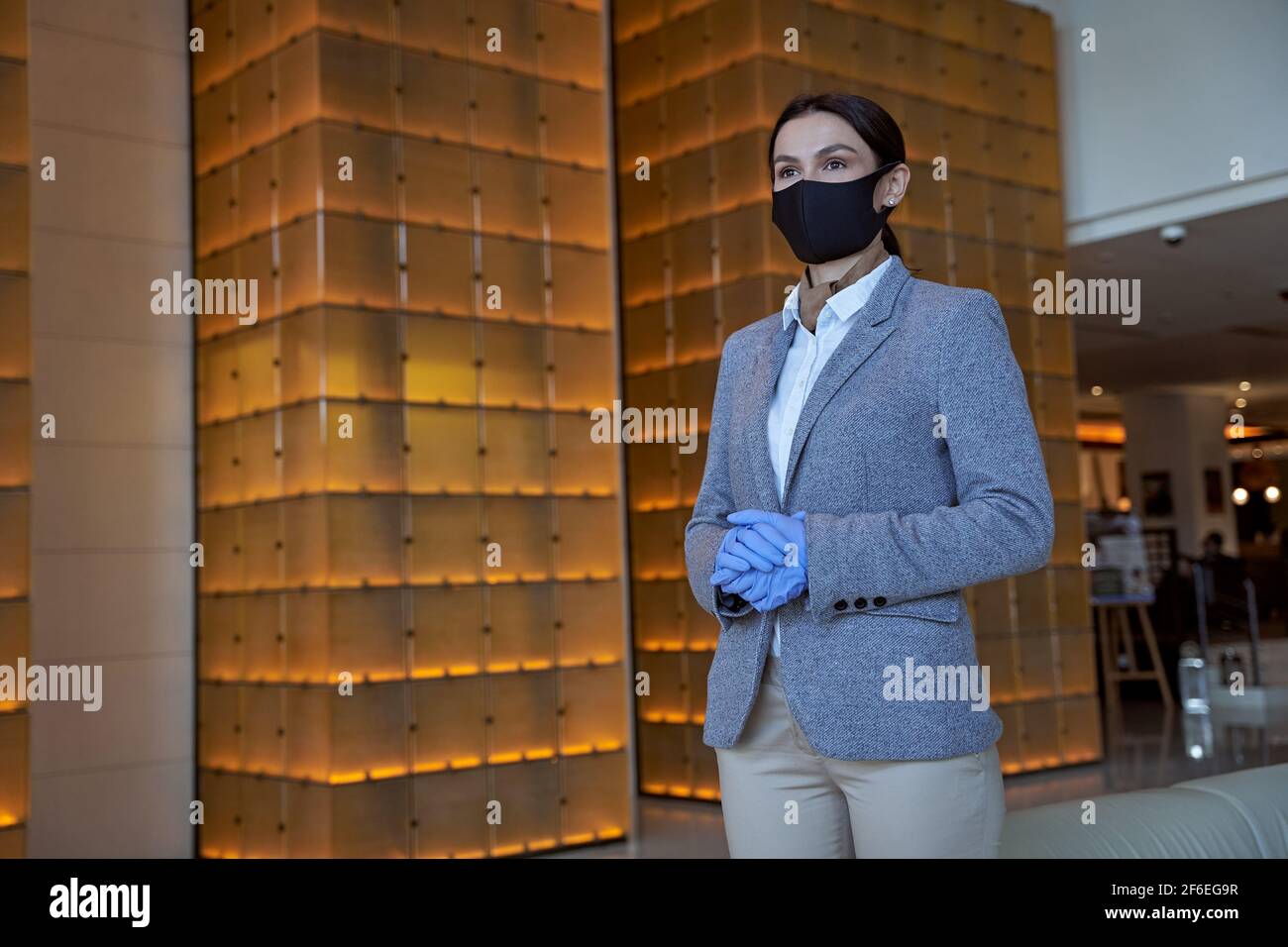 Receptionist standing in hotel lobby hi-res stock photography and ...