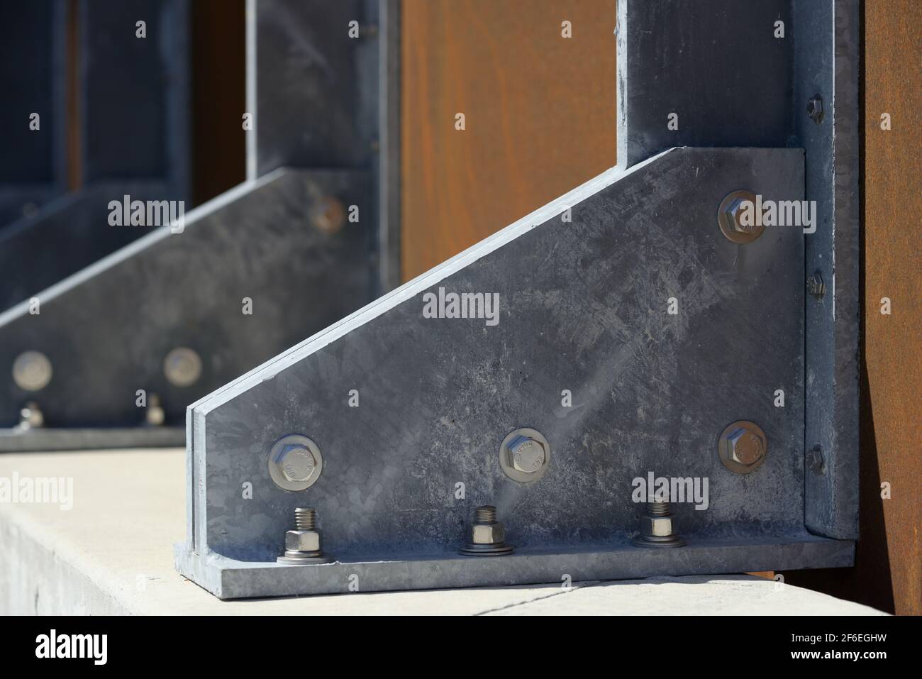 triangular metal sign brackets or supports bolted to concrete Stock ...