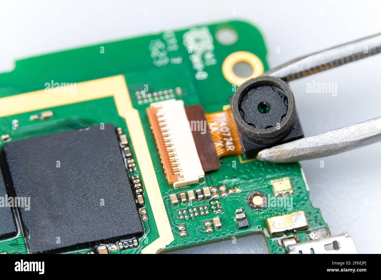 Fix the phone.A technician or master repairs a mobile phone, he ...