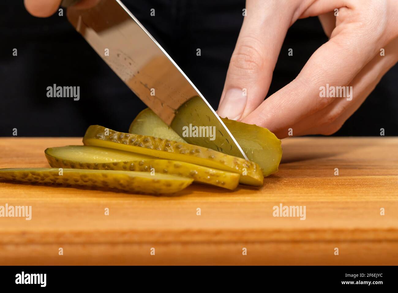 Womens hands cut pickled cucumber hi-res stock photography and images ...