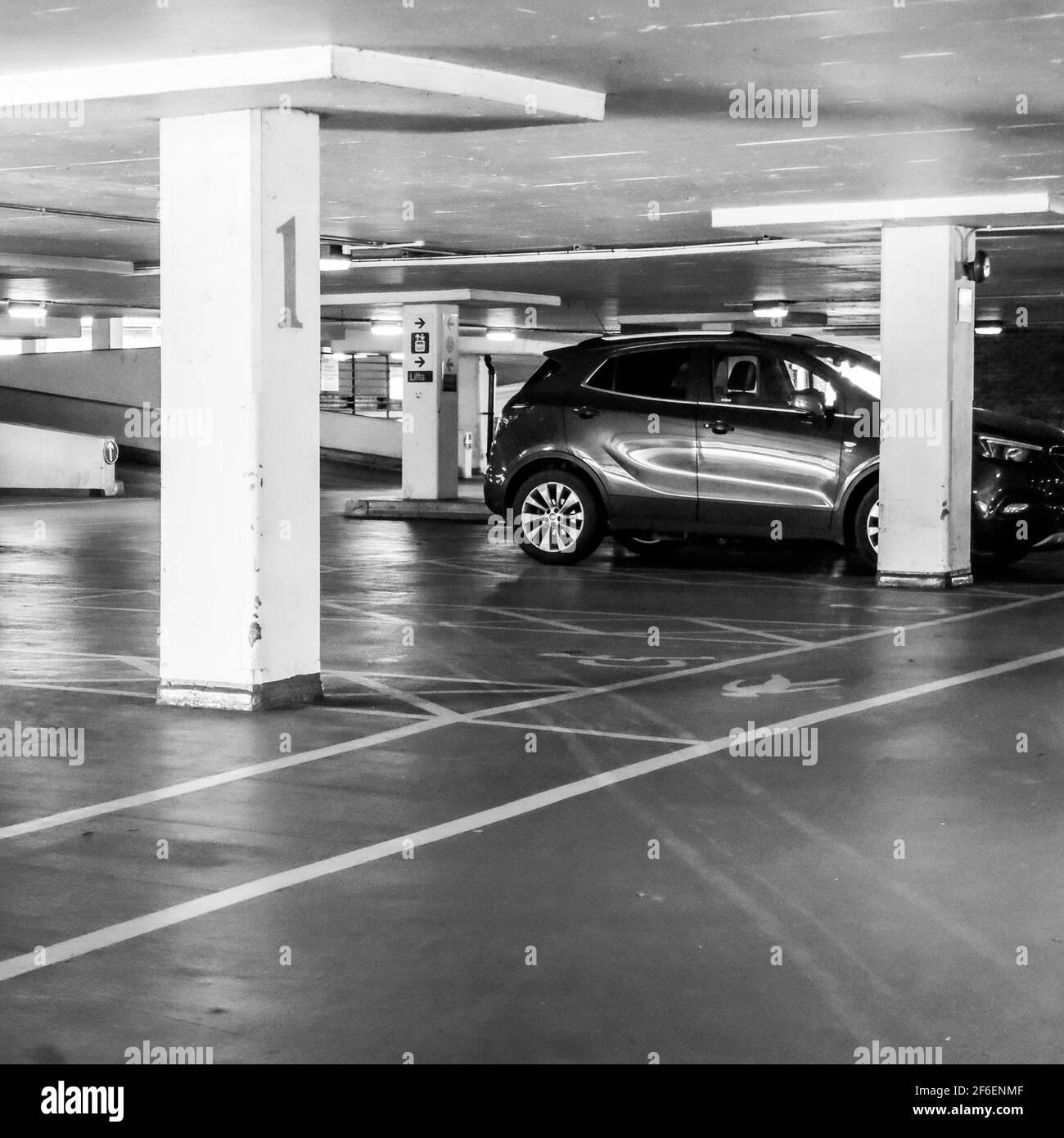 Black And White Image Of A Public Council Car Park With One Car Or ...