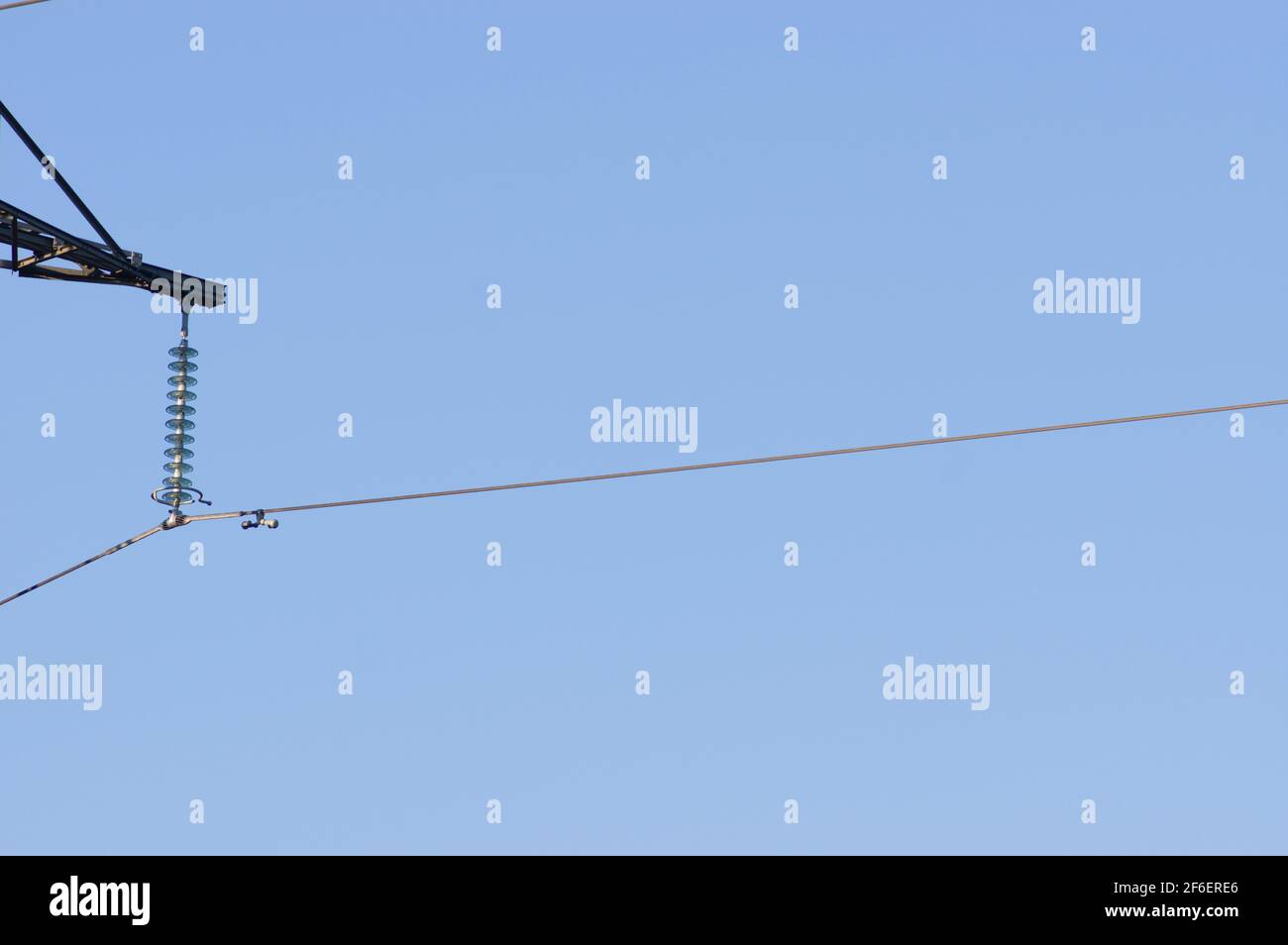 Closeup of a high voltage power transmission cable hanging on na ...