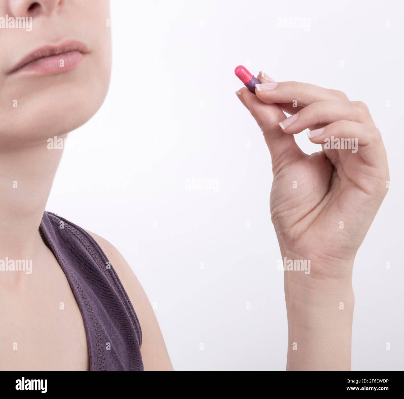 a young woman taking pill over white background with copy space Stock ...