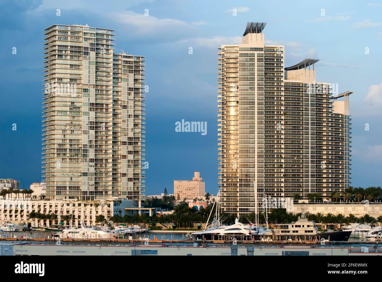 The evening view of Miami Beach residential skyscrapers with marina ...