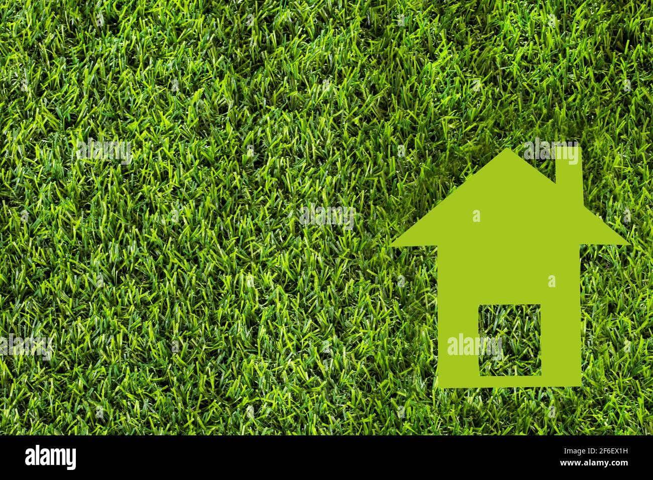Paper house on green grass - Ecological concept Stock Photo - Alamy