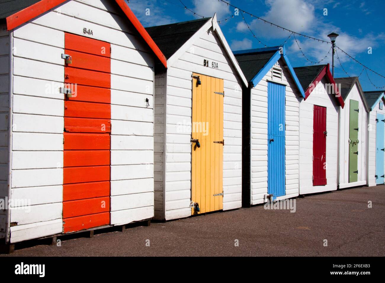 Row of multi color beach huts Stock Photo - Alamy