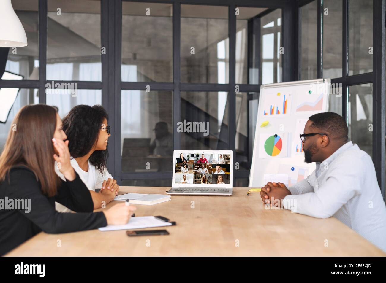 Multiracial work team using app on the laptop for connect with ...