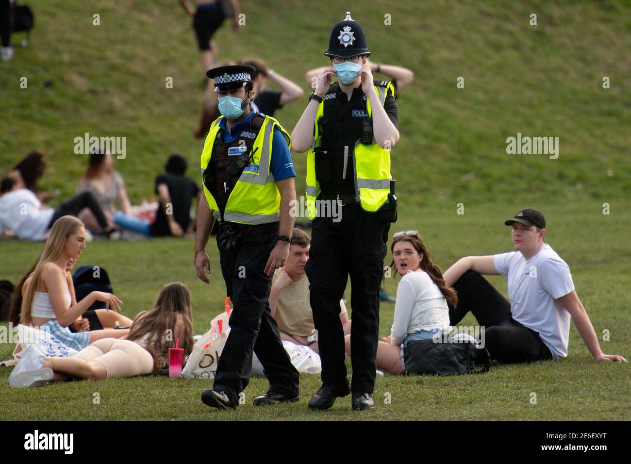 Police officers overlook people enjoying the warm weather at the Forest ...