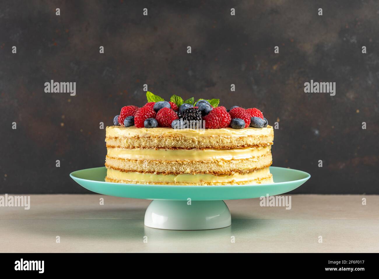 Homemade cake with fresh berries on dark background Stock Photo - Alamy