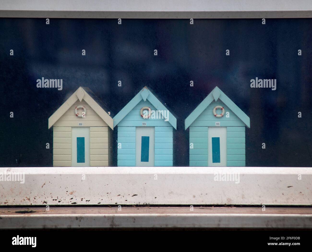 Miniature beach huts in the window of a Brighton home Stock Photo - Alamy