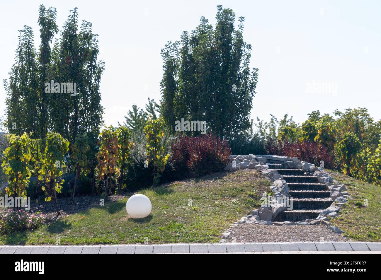 Roundabout with flowers and waterfall Stock Photo - Alamy