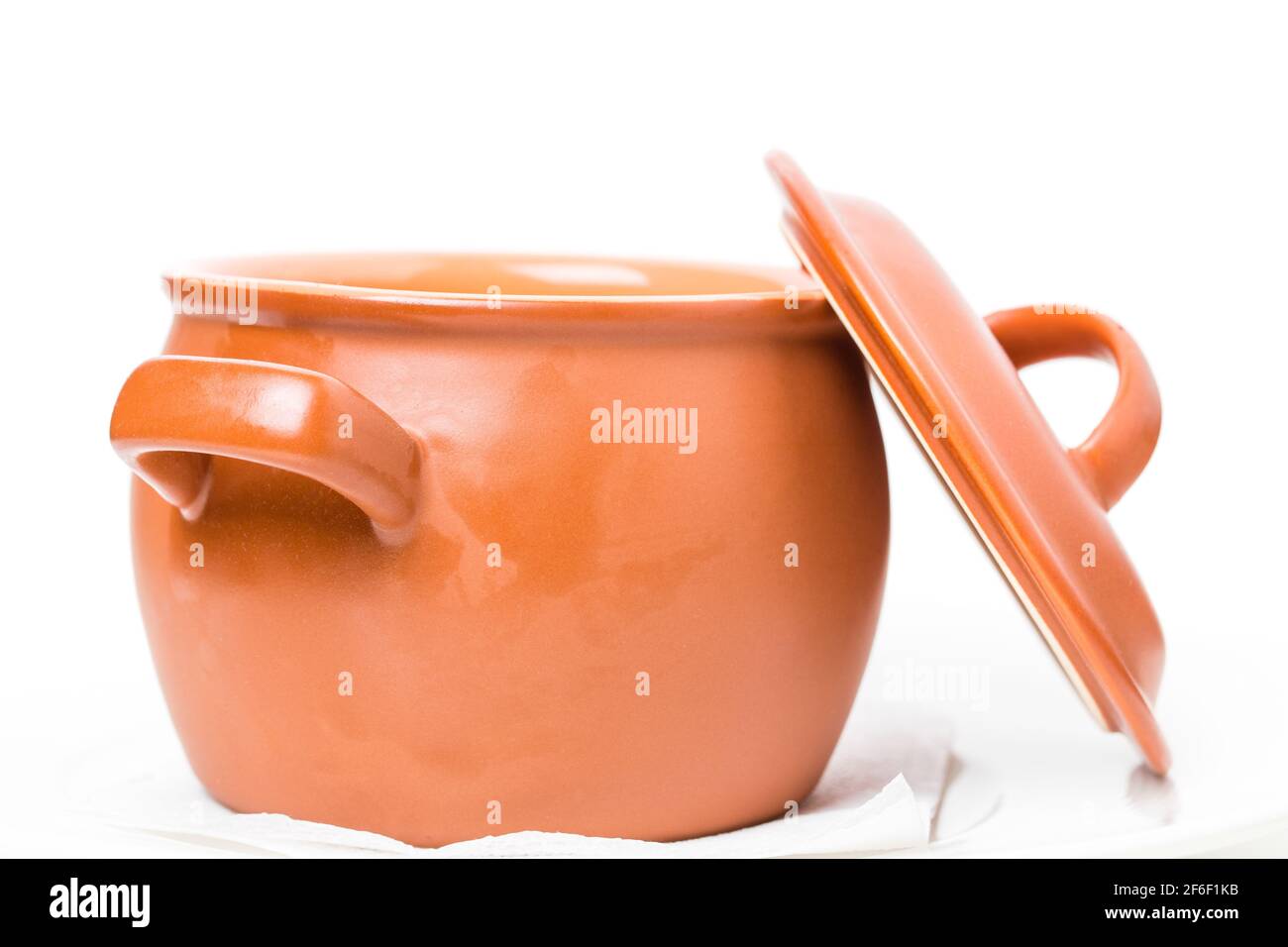 Closeup of orange clay pot. Isolated on a white background Stock Photo ...
