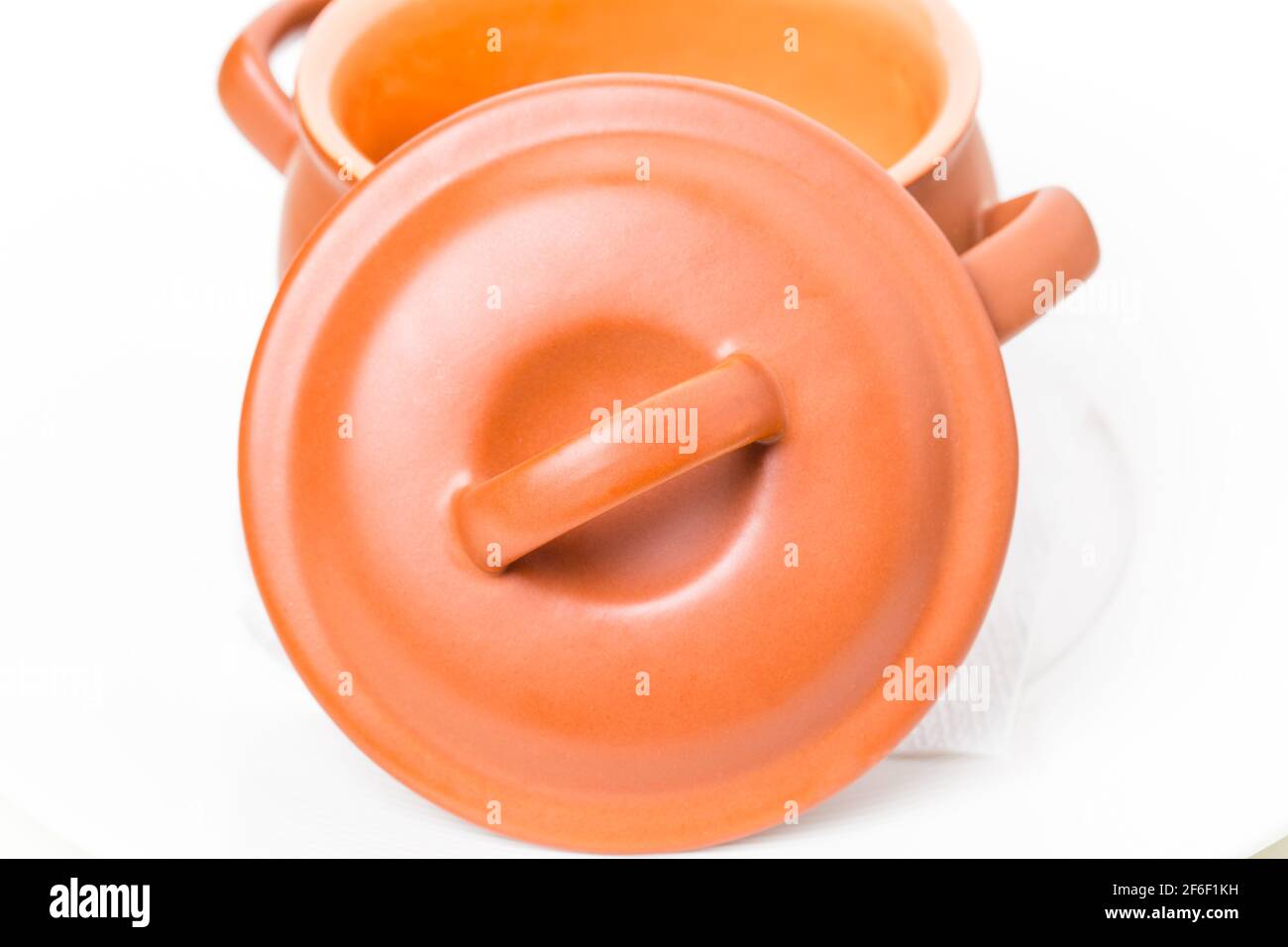 Closeup of orange clay pot. Isolated on a white background Stock Photo ...