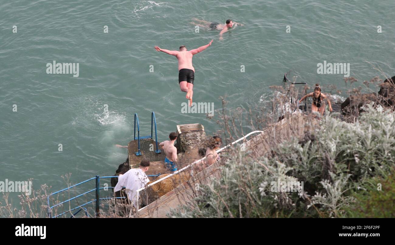 People enjoy the spring sunshine at the Vico bathing place, Hawk Cliff ...