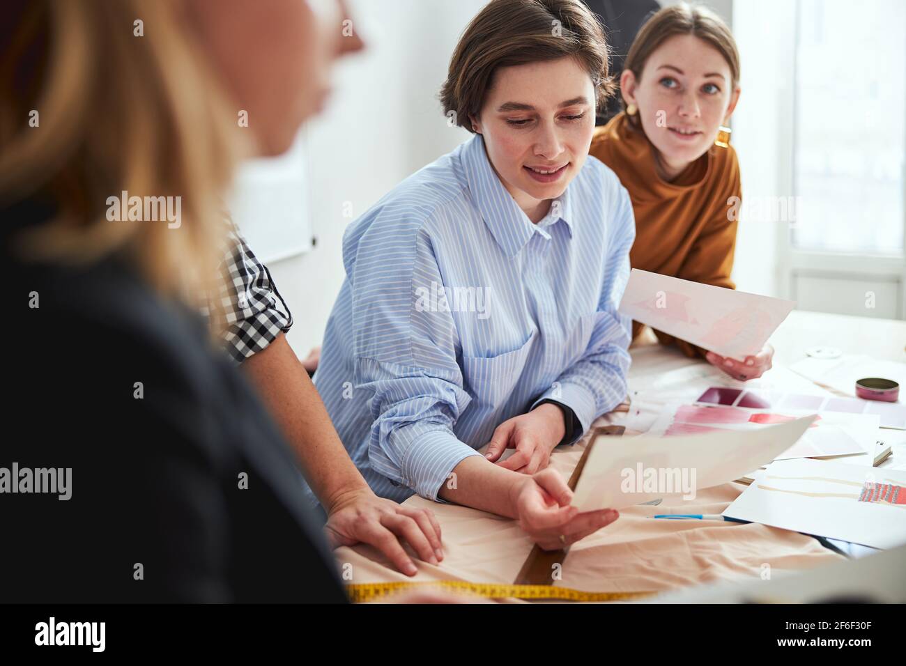 Admiring the drawings of colleagues while working on design Stock Photo ...