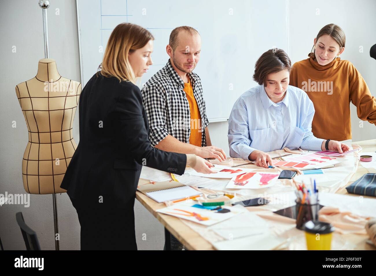 Creative fashion designers comparing the colors in studio Stock Photo ...