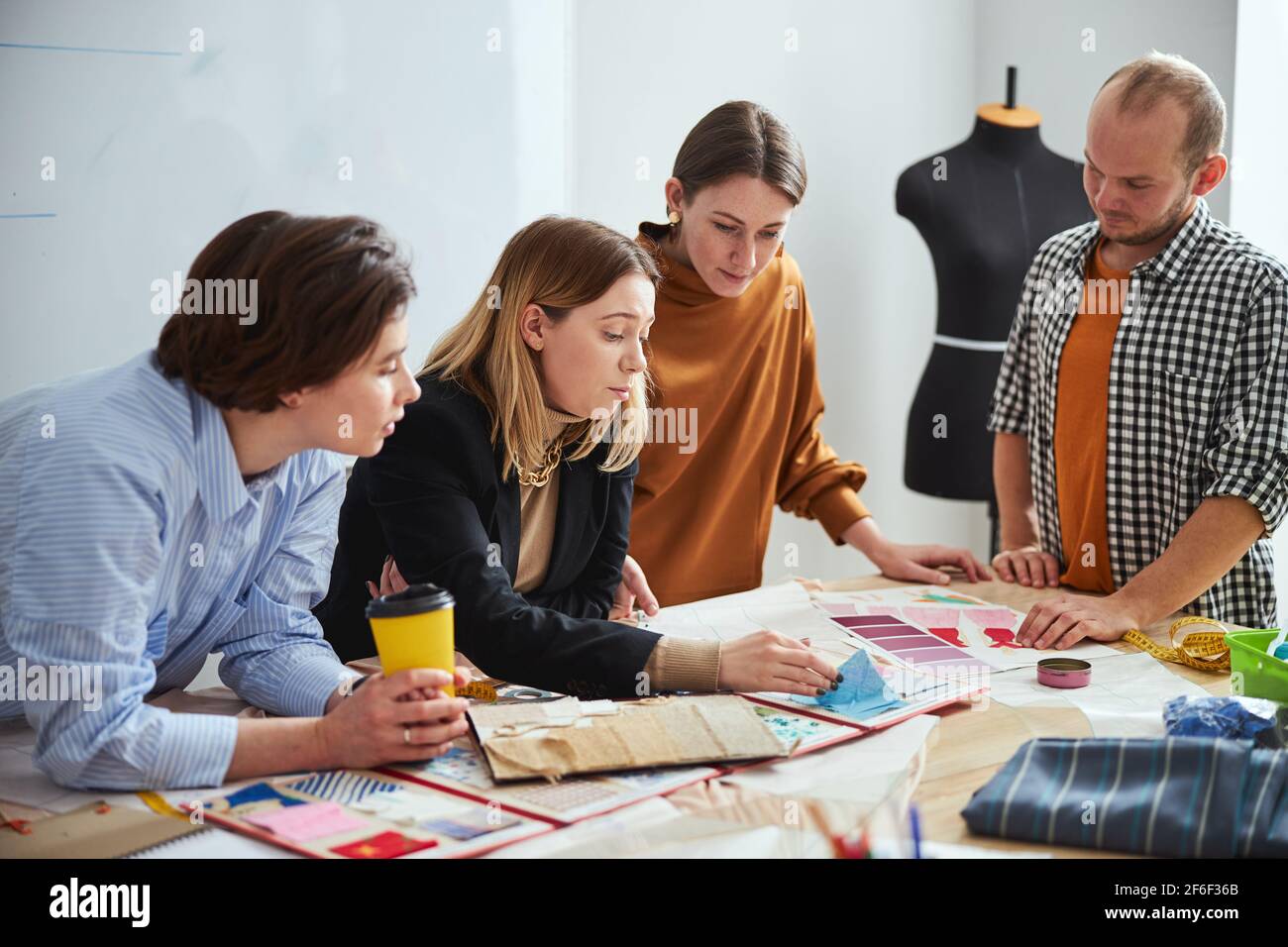 Designers trying to choose one suitable fabric Stock Photo - Alamy