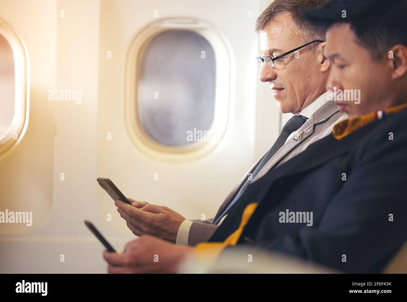 Businessman cell phone plane hi-res stock photography and images - Alamy