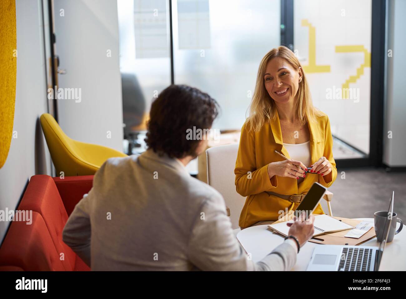 Positive delighted employer talking to her future colleague Stock Photo ...