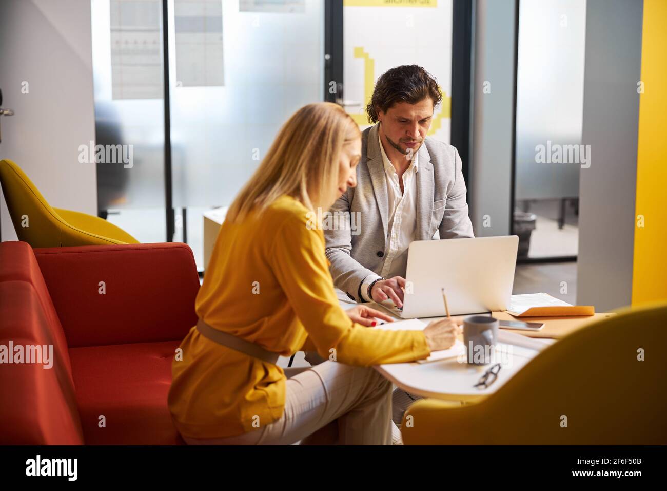 Concentrated female person making notes after conversation Stock Photo ...