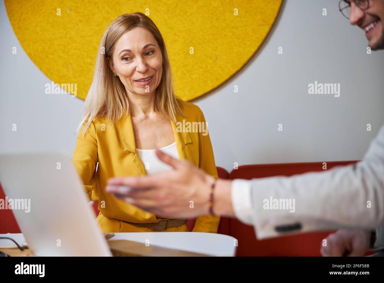 Kind female person looking at screen of laptop Stock Photo - Alamy