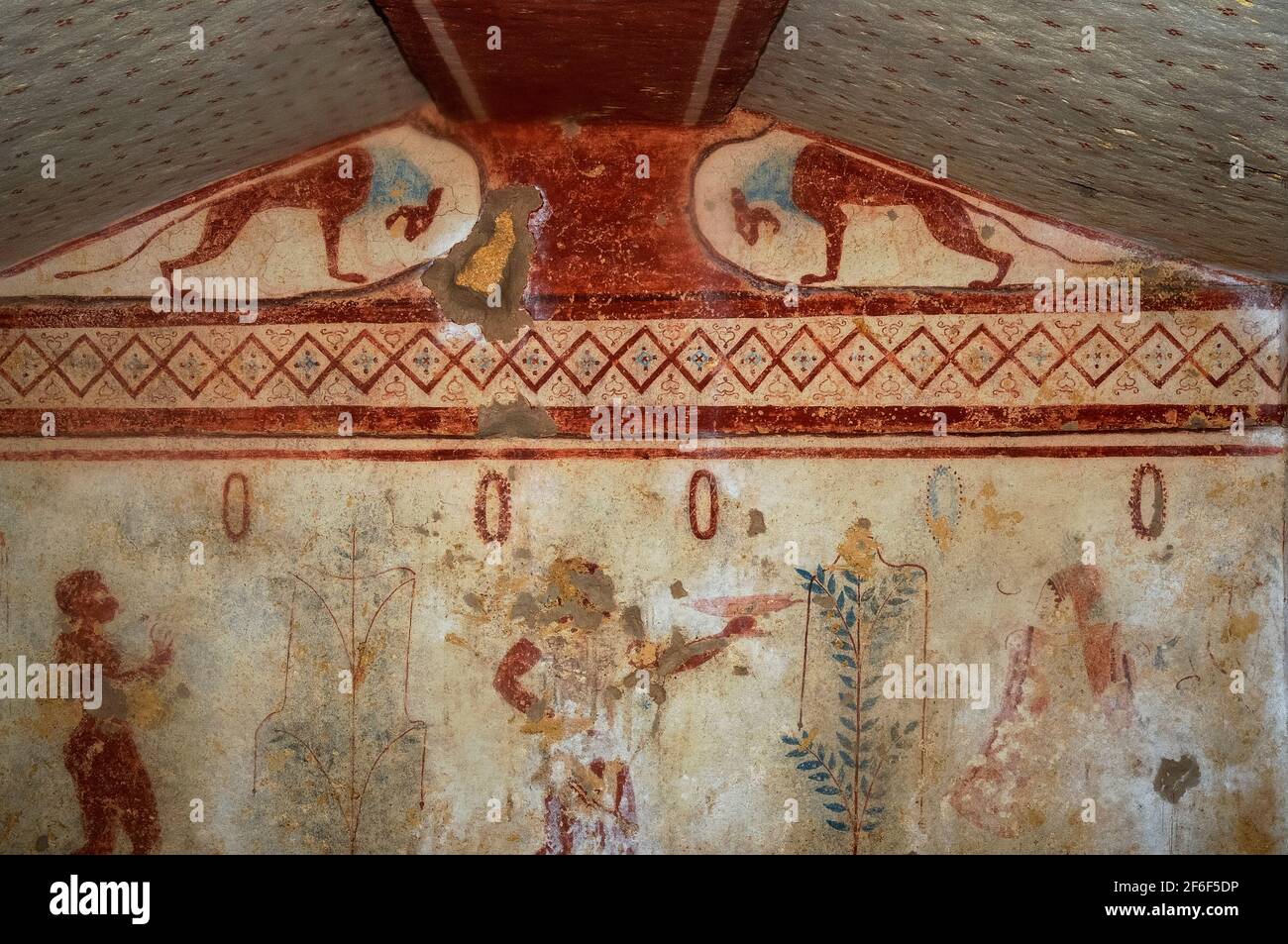 Two lions with light blue manes face each other above a decorative ...