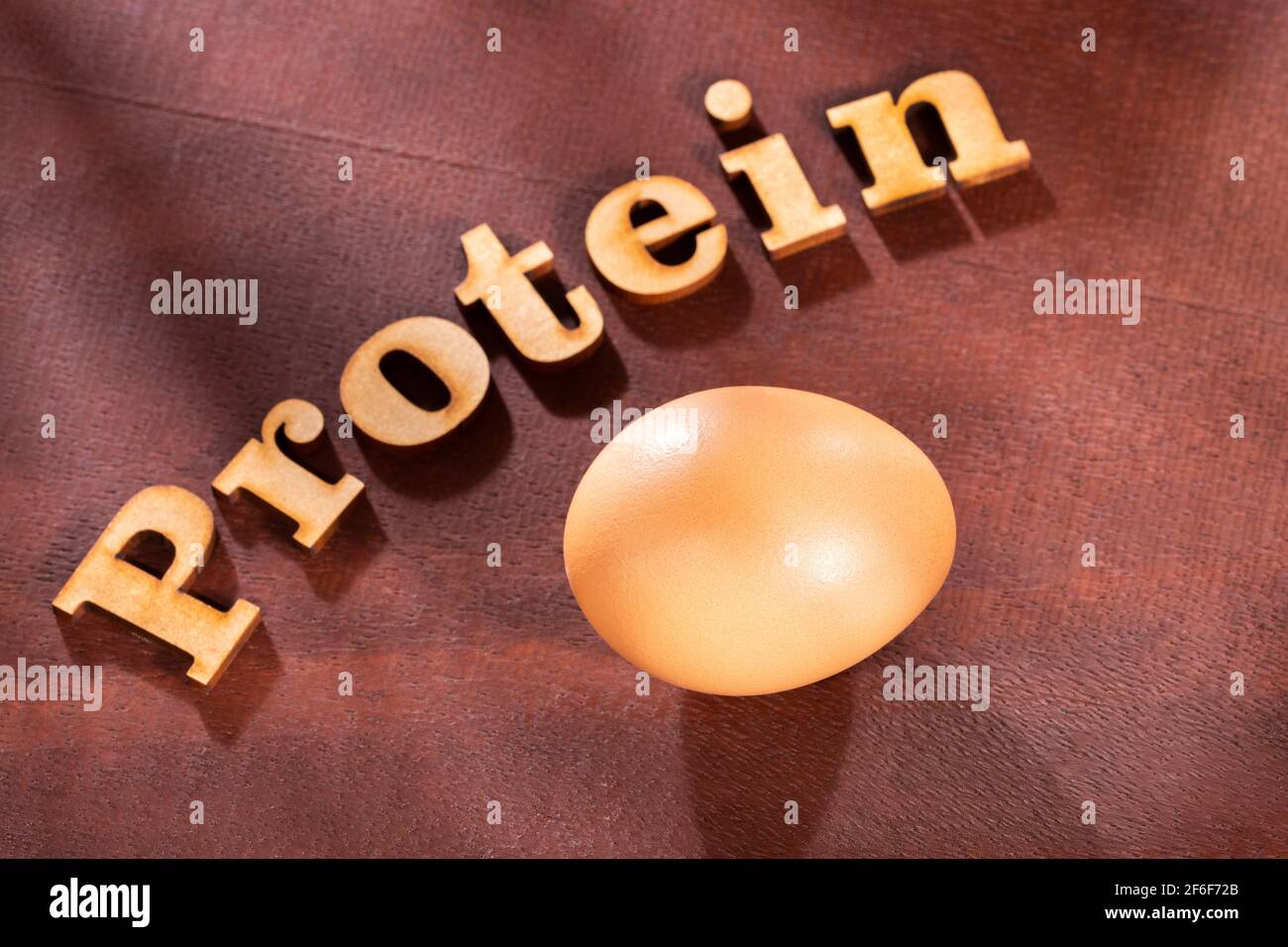 Protein word in wooden letters - Brown Chicken Egg Stock Photo - Alamy
