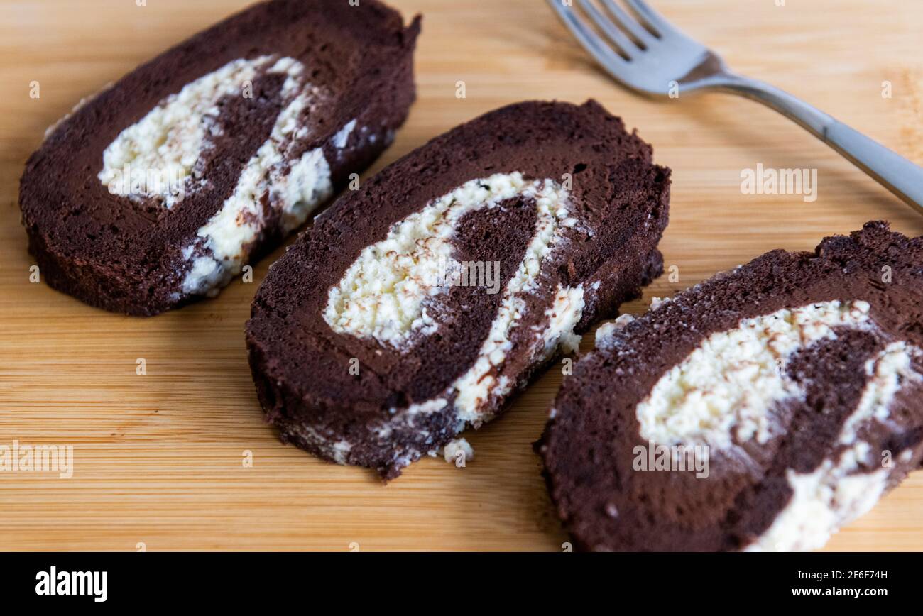 Triple Chocolate Log sponge cake Stock Photo - Alamy