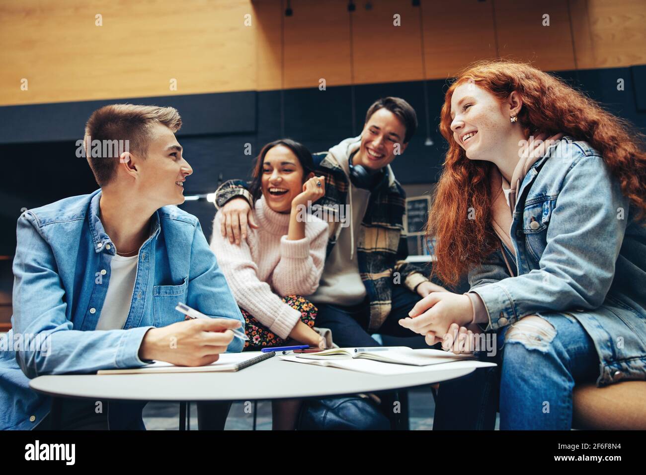 Group teenagers sitting table hi-res stock photography and images - Alamy