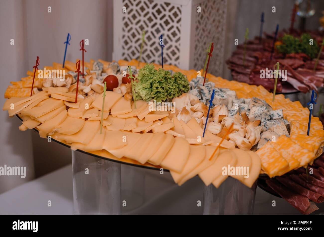 Slicing different types of cheese. Wedding buffet Stock Photo - Alamy