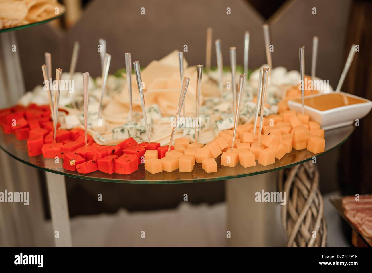 Slicing different types of cheese. Wedding buffet Stock Photo - Alamy