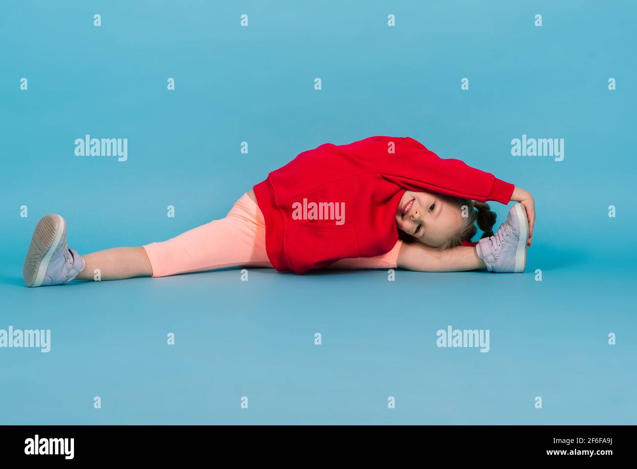 Child girl doing fitness exercises, split, studio shot Stock Photo - Alamy