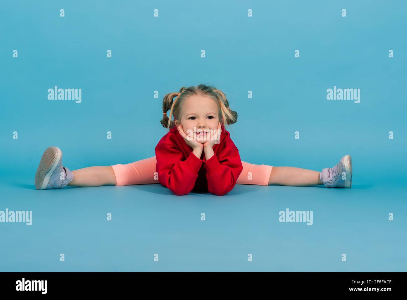 Child girl doing fitness exercises, split, studio shot Stock Photo - Alamy