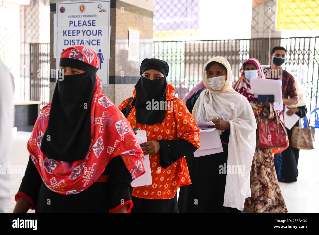 Migration workers seen waiting in a social distance queue in front of ...
