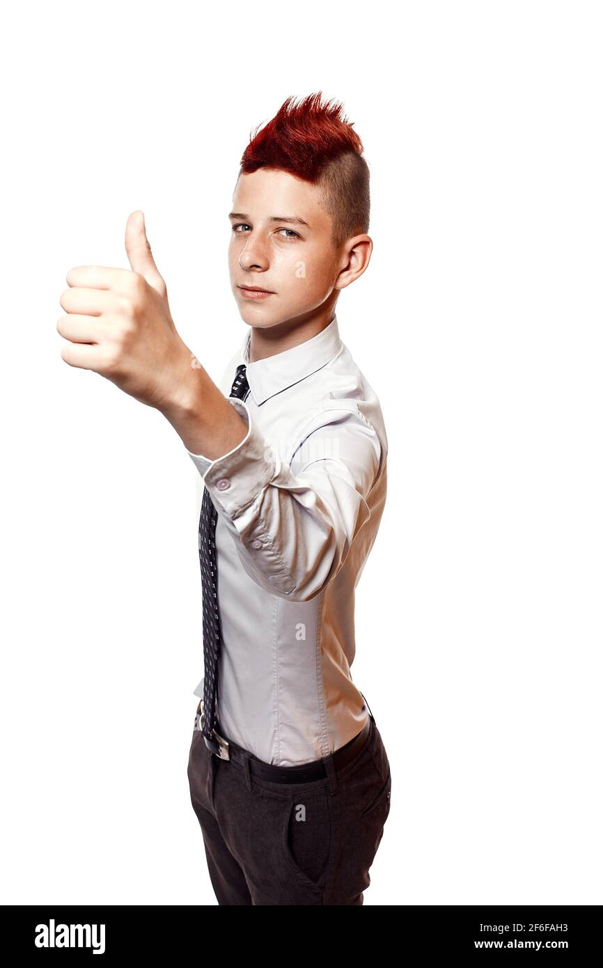 A smiling teenager with red mohawk wearing shirt and tie shows his ...