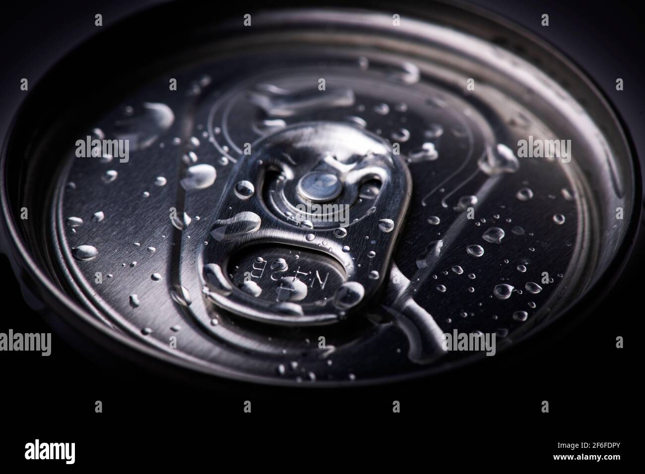 Closeup aluminum drink can with water drops on the lid, on a dark ...