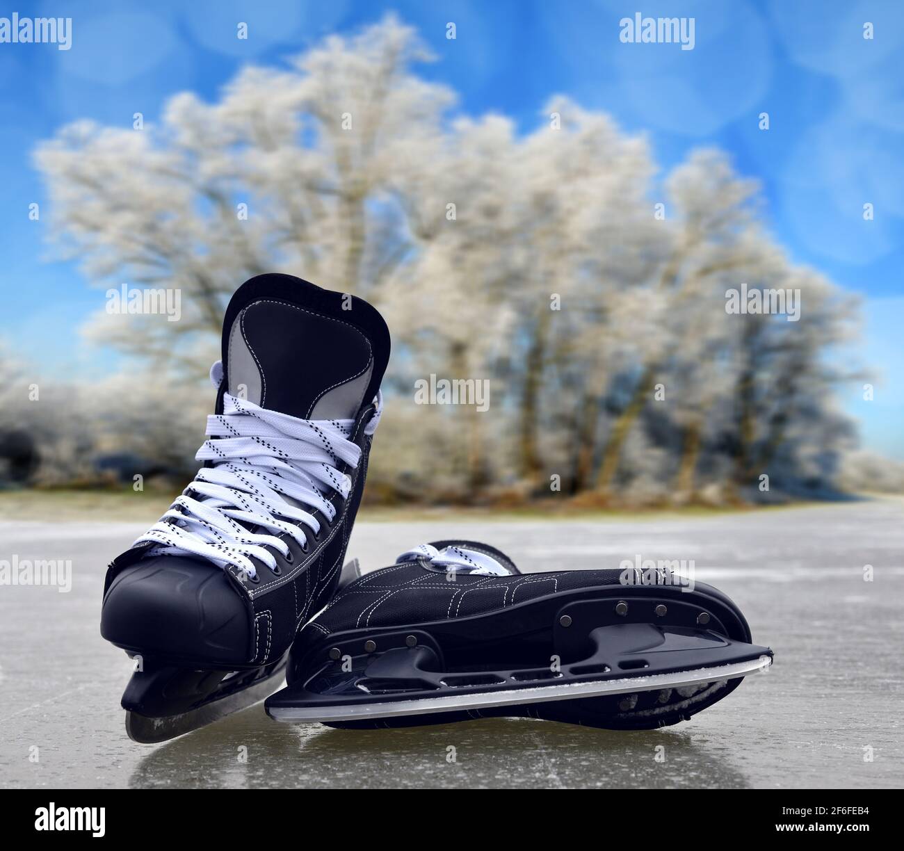 Black hockey skates on a ice rink Stock Photo - Alamy