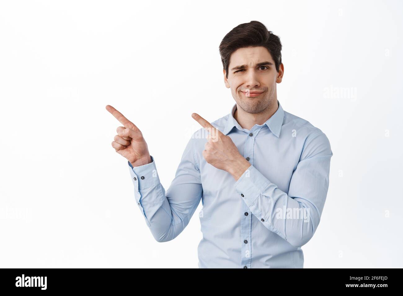 Skeptical male manager, office clerk pointing left and smirk doubtful ...