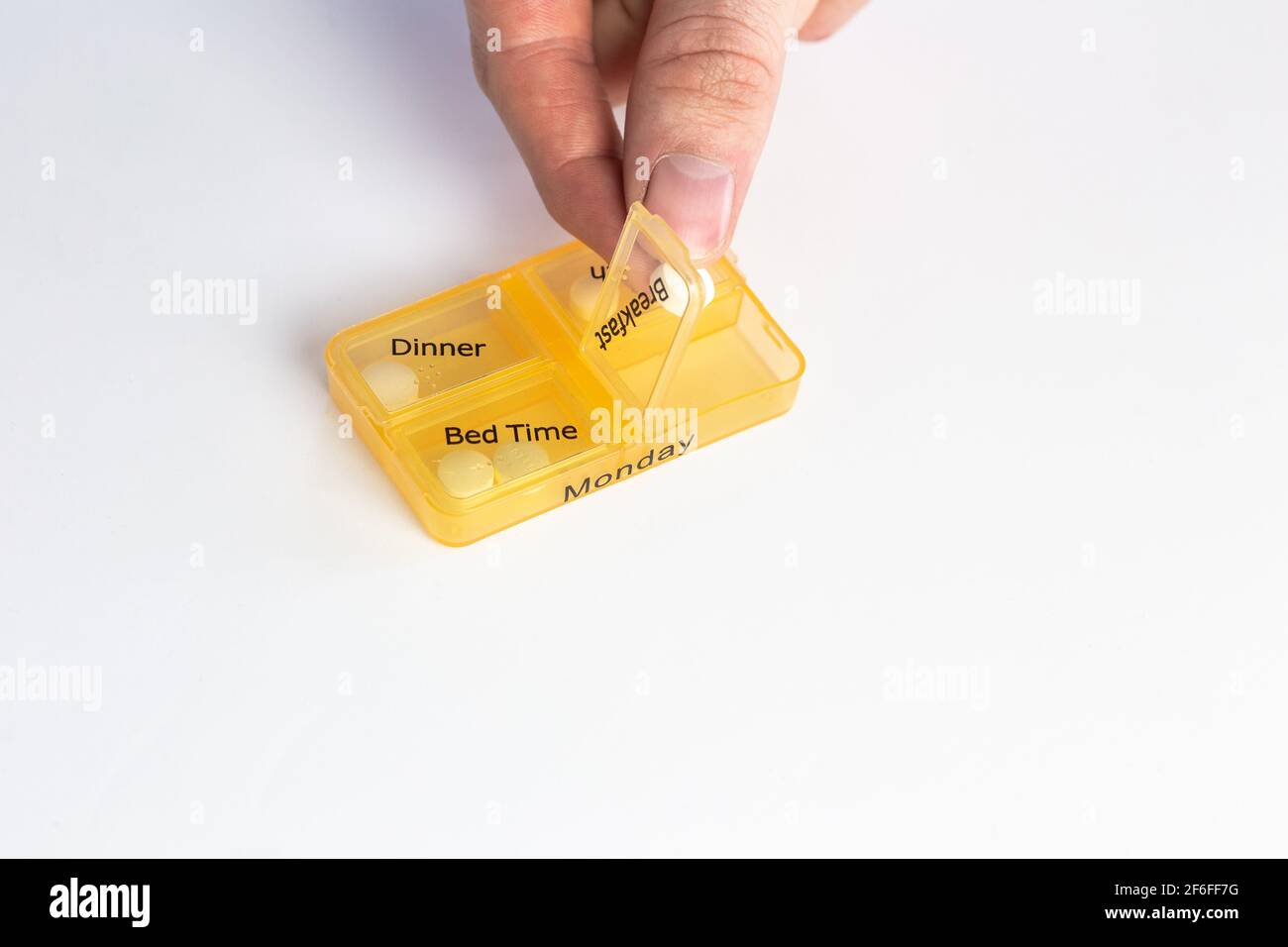 Hands of human with pill reminder box, taking medication isolated on ...