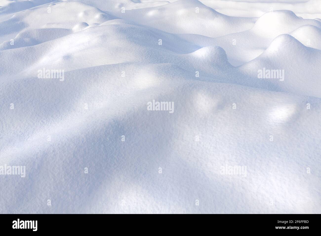 Winter season scene. Texture of snow waves in bright sunlight. With a ...