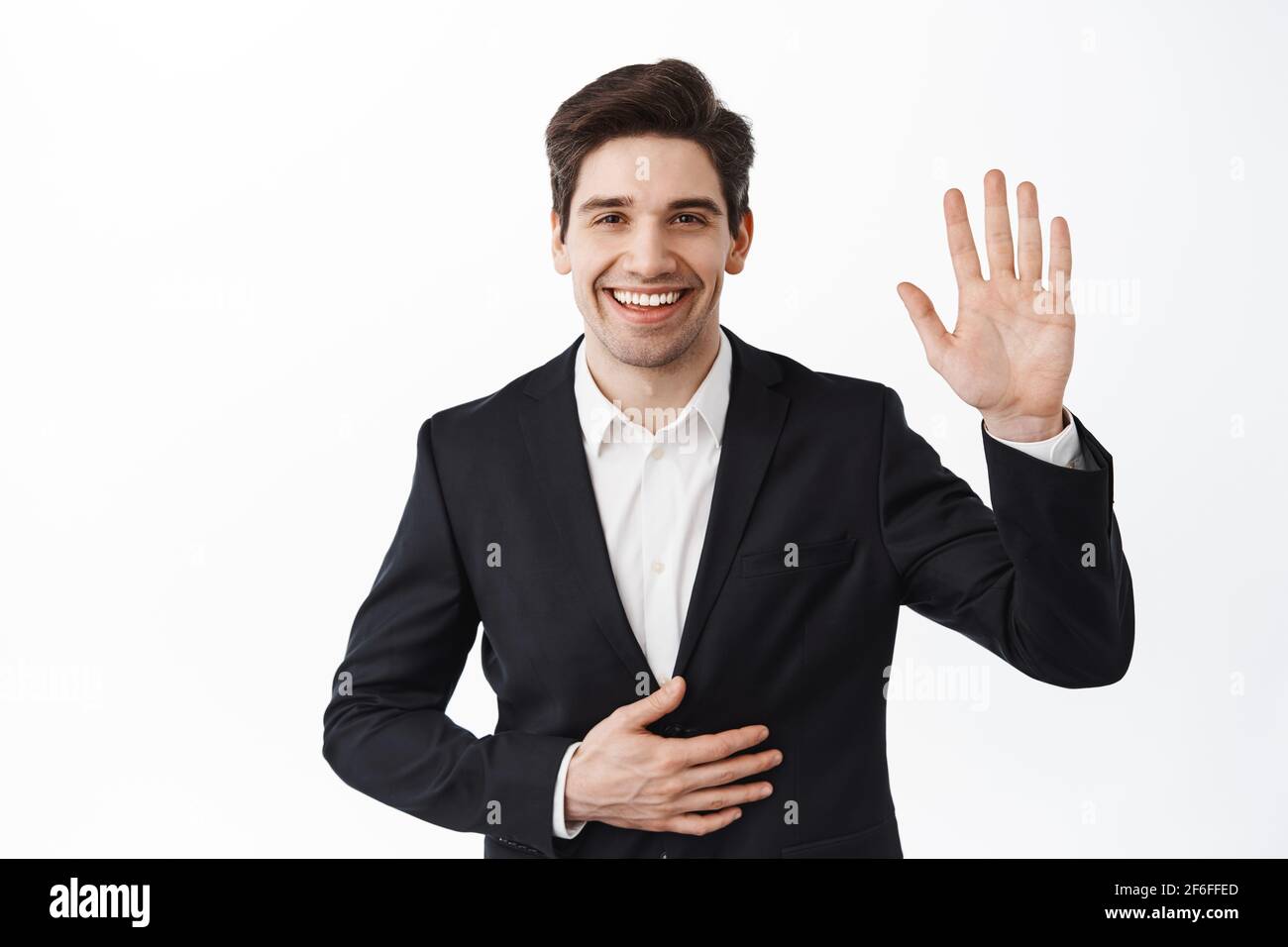 Friendly man in suit waving hi-res stock photography and images - Alamy